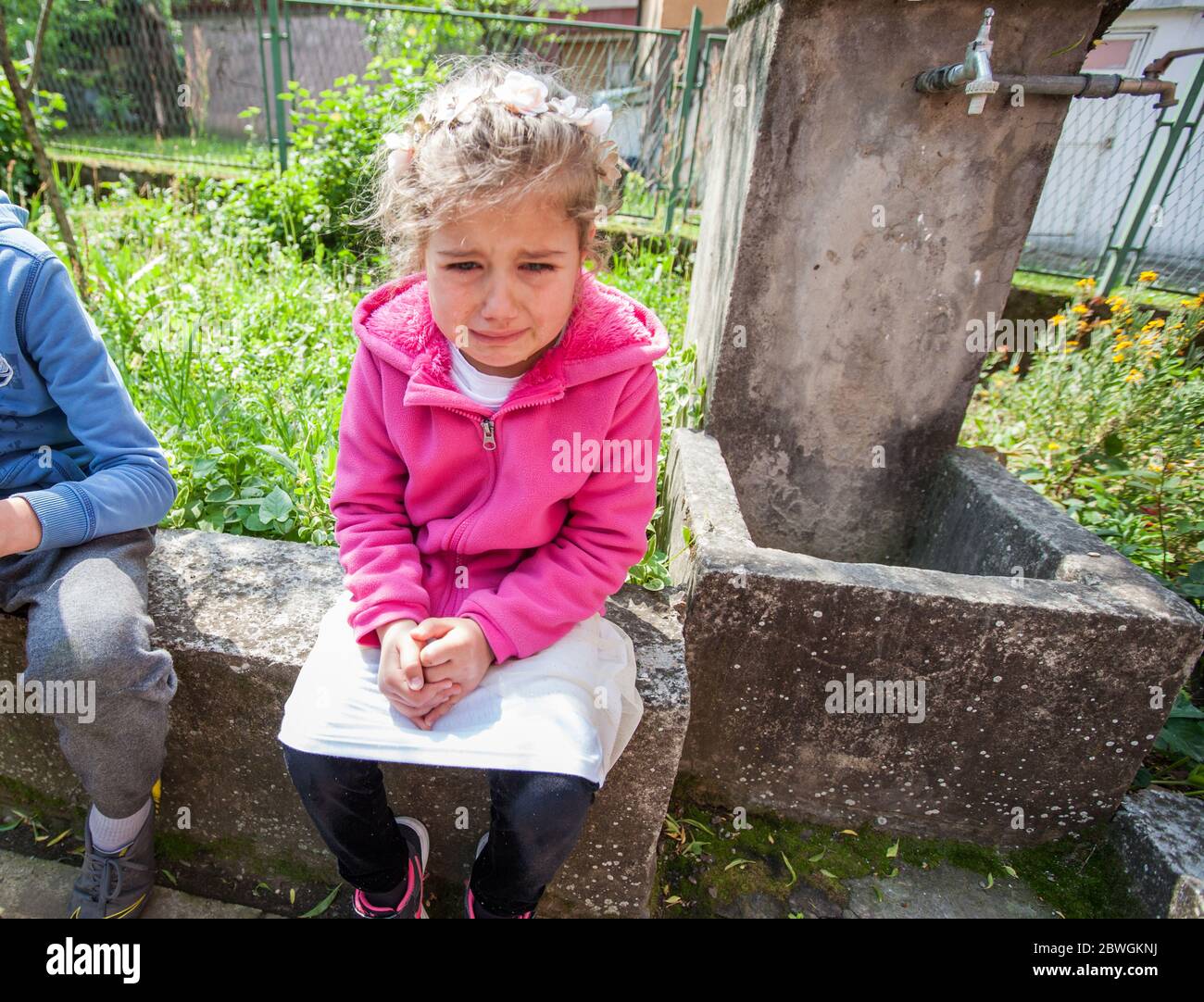 Portrait of sad little girl crying in backyard Stock Photo - Alamy