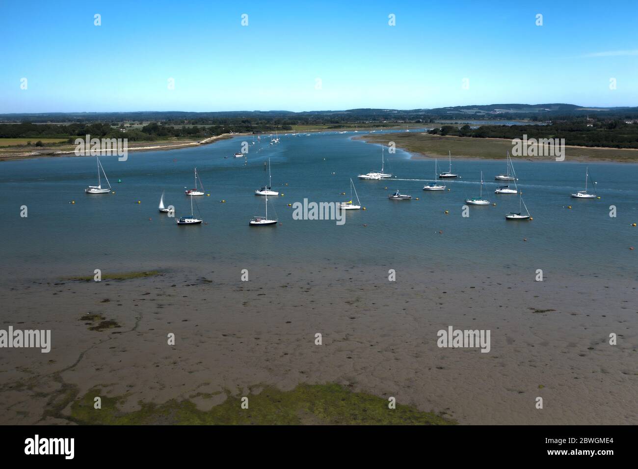 Aerial view of the estuary near Itchenor looking inland with the boats ...