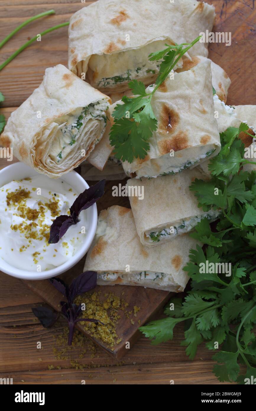 Lavash roll stuffed with cheese and herbs Stock Photo - Alamy