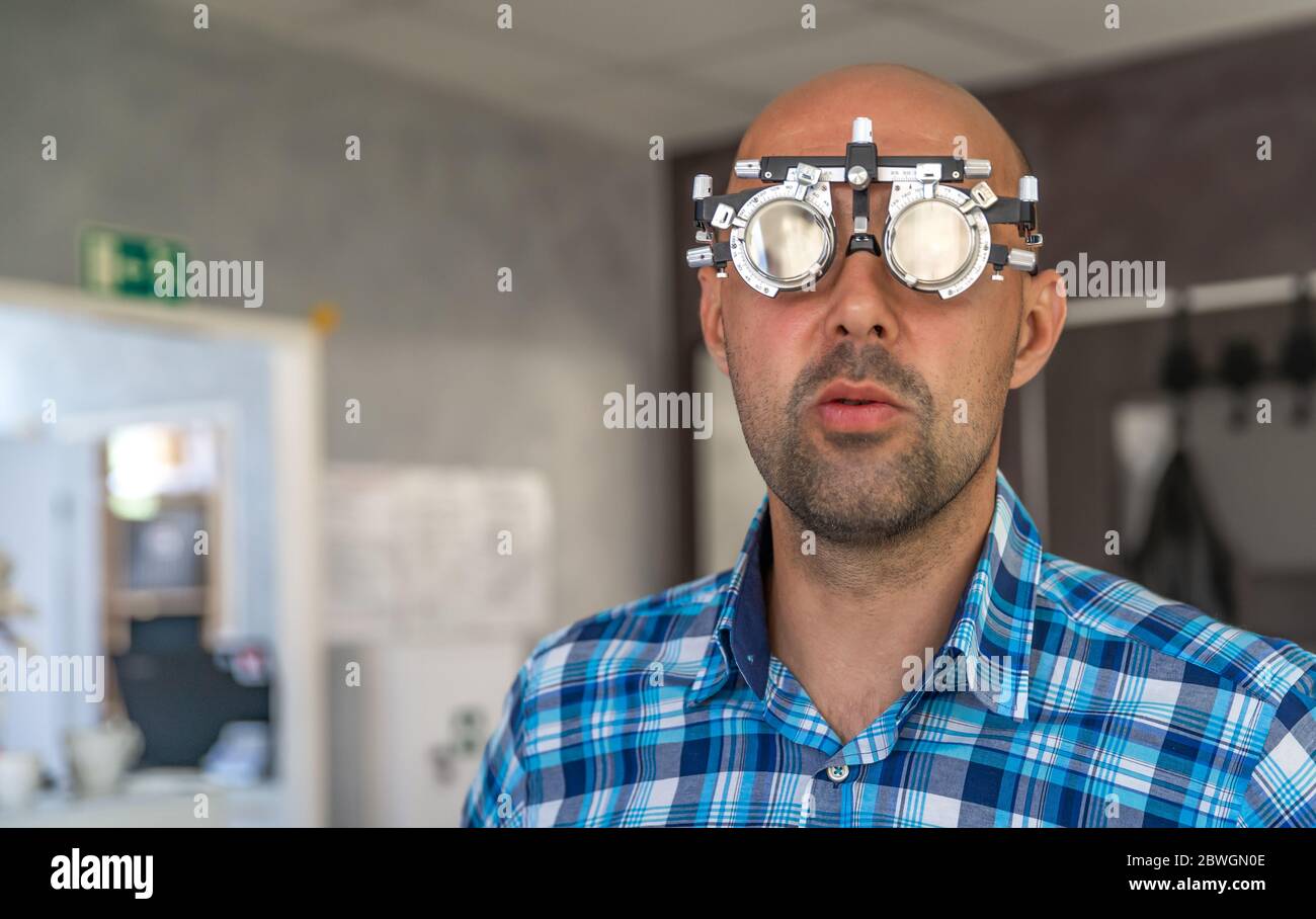examination of the eyes of a man with special glasses, measurement of ...