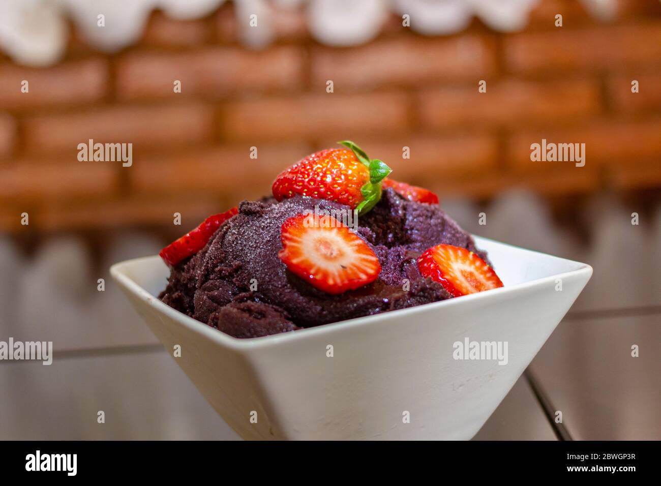 Acai cream topped with strawberry Stock Photo - Alamy