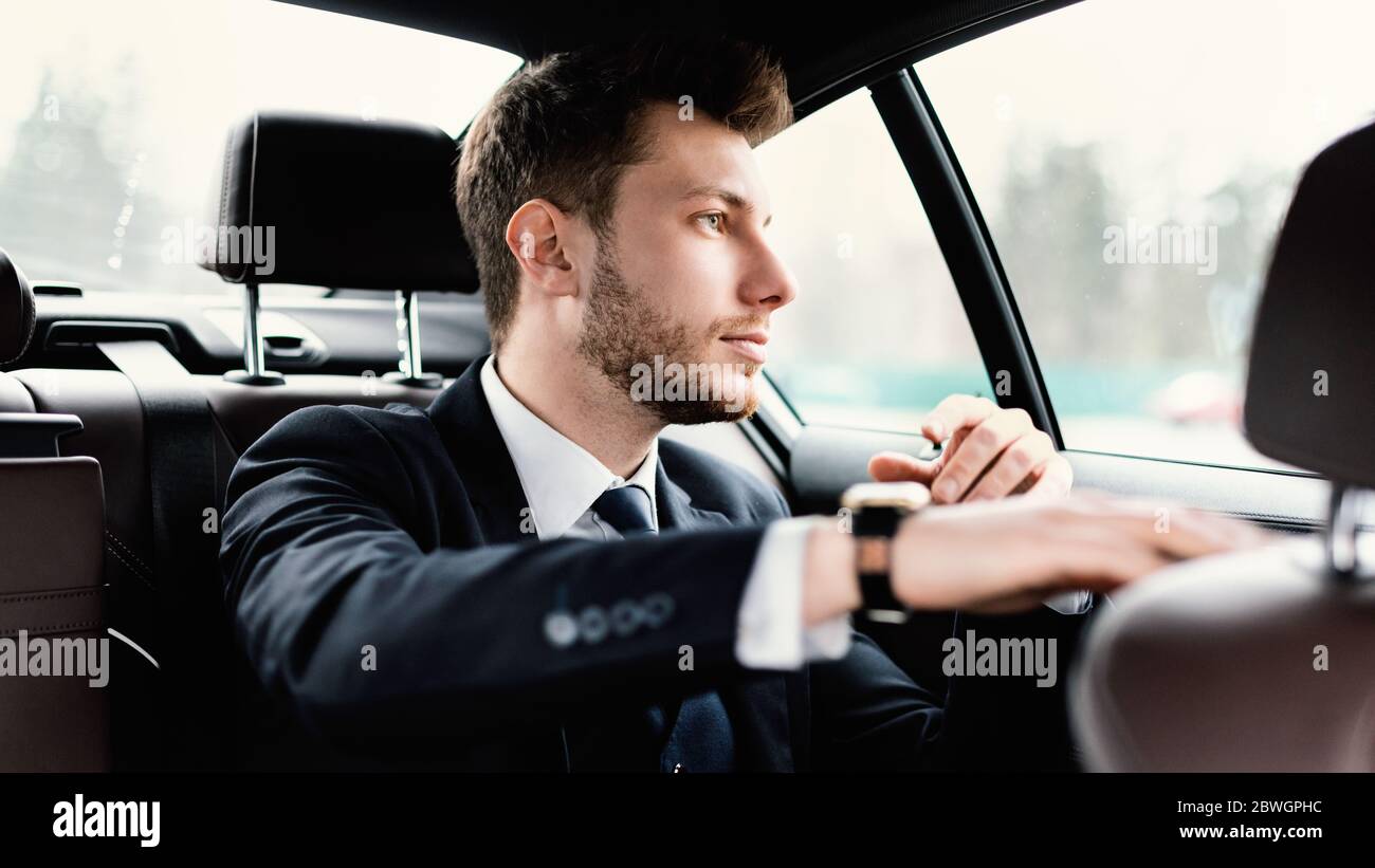 Handsome man looking out the window of the car hi-res stock photography ...