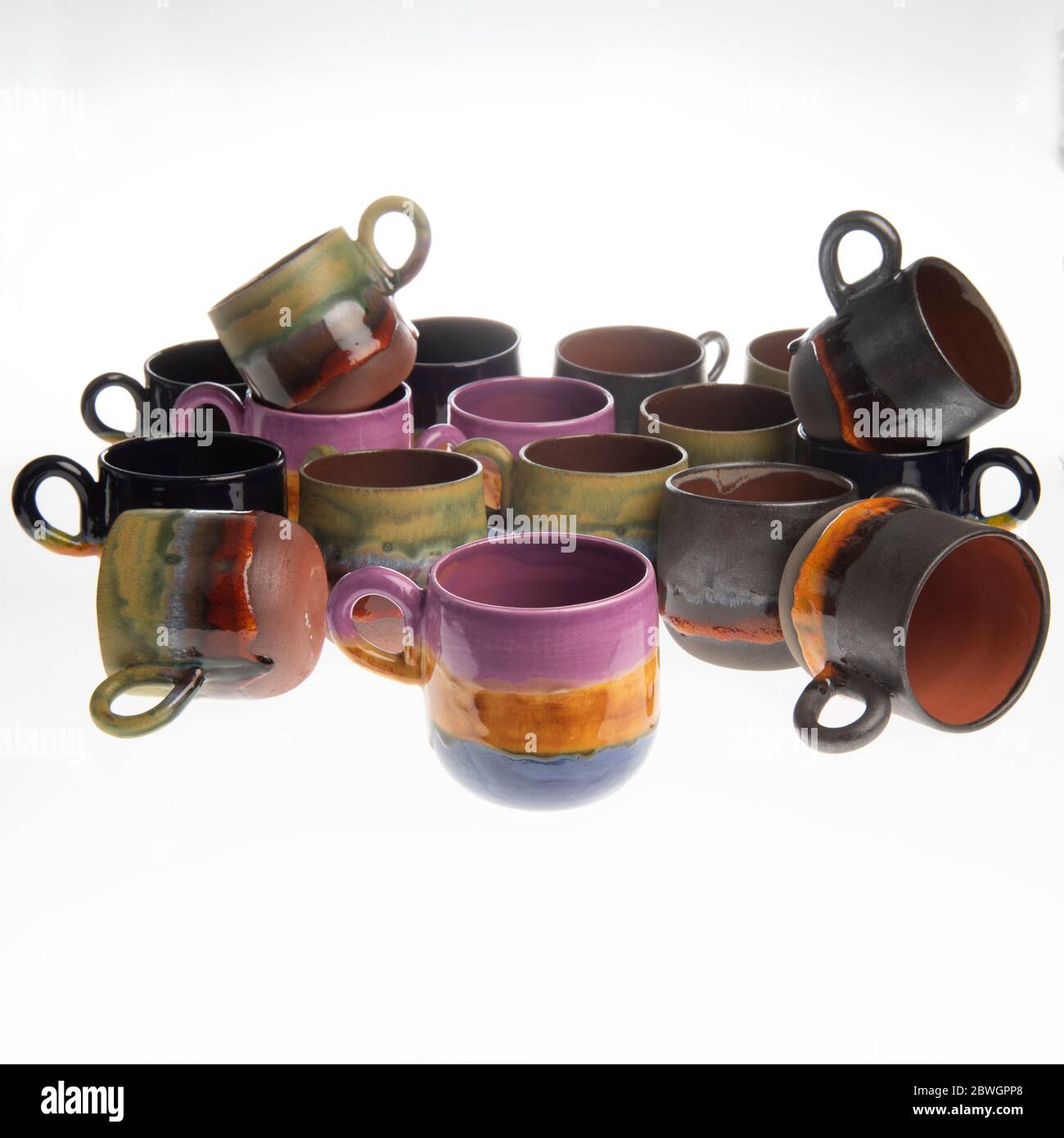 colorful handmade ceramic coffee cups on white background isolated ...