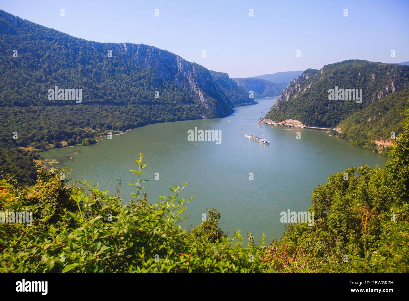 Danube river landscape. The cruiser ship passes through the narrowest ...