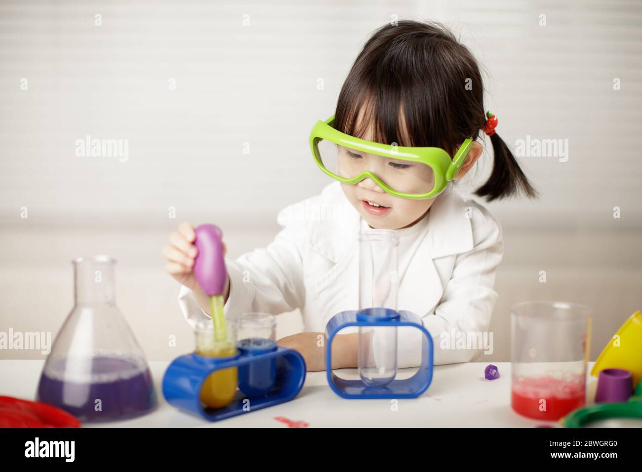 toddler girl pretend play scientist role for homeschooling Stock Photo ...