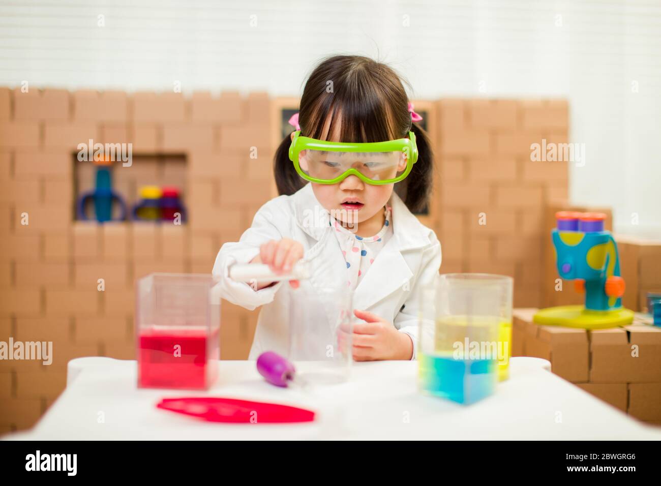 toddler girl pretend play scientist role for homeschooling Stock Photo ...