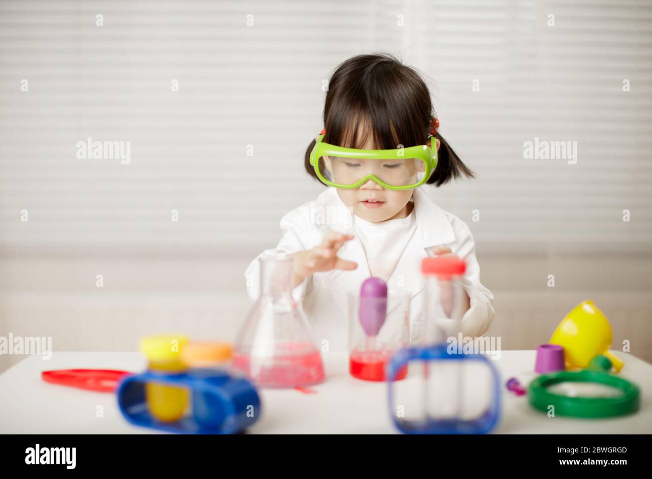 toddler girl pretend play scientist role for homeschooling Stock Photo ...
