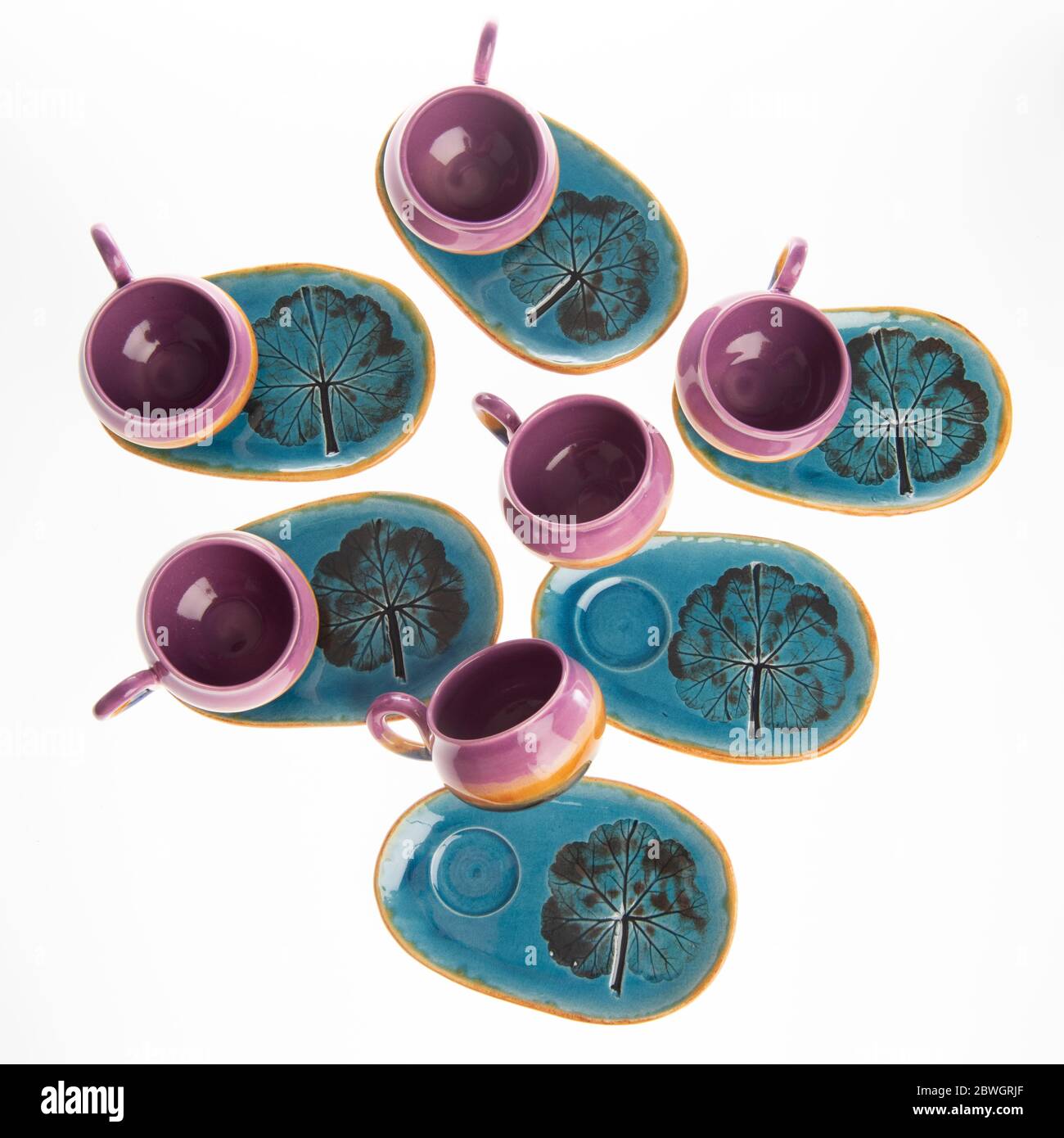 colorful handmade ceramic coffee cups on white background isolated ...