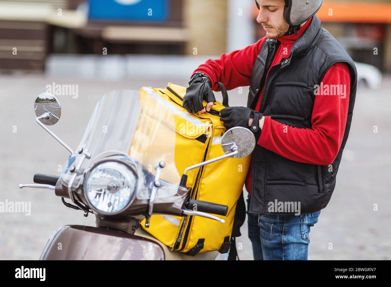 Courier Guy With Bag On Scooter Delivering Meals Standing Outdoor Stock ...