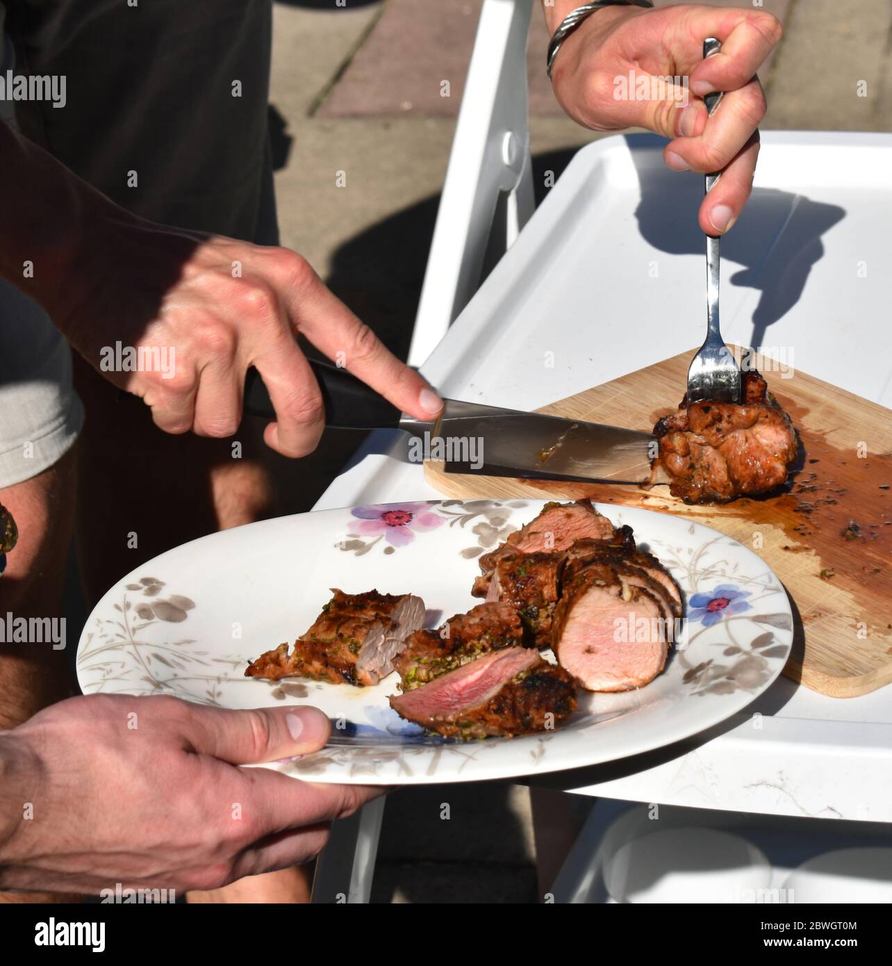 Roasted meat is the glue of friendship Stock Photo - Alamy