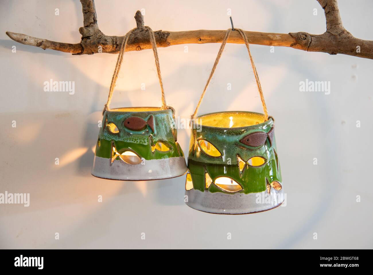 handmade ceramic candle holders with warm light Stock Photo - Alamy