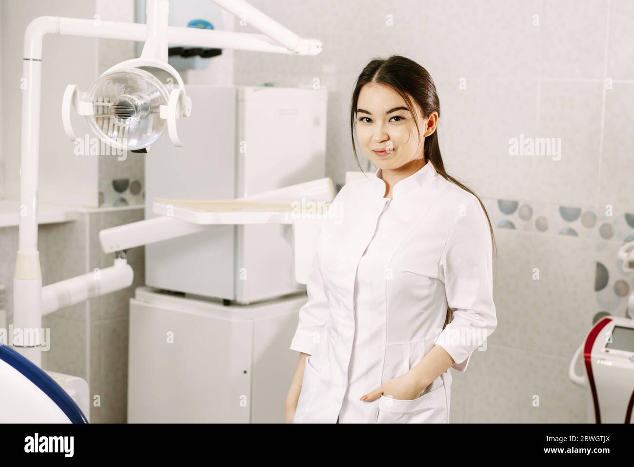 cheerful female dentist smiling in her office. dentistry student ...