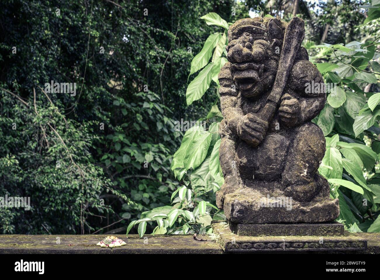 Traditional Balinese guardian statue at entrance of Pura Gunung Lebah ...