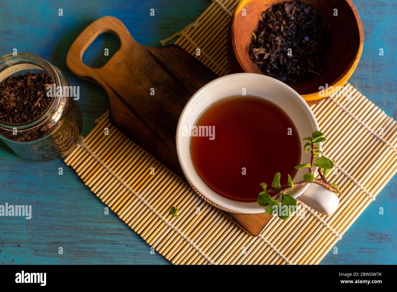 black tea on a vintage background, for a hot day, organic with a bottle ...