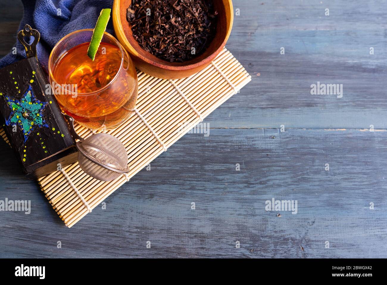 black tea on a vintage background, for a hot day, organic with a bottle ...