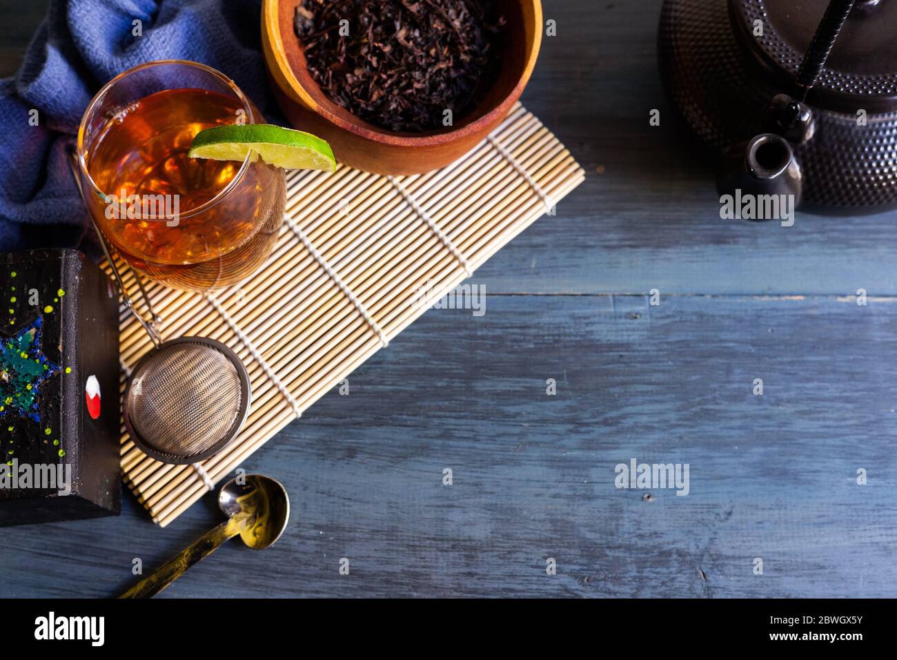 black tea on a vintage background, for a hot day, organic with a bottle ...