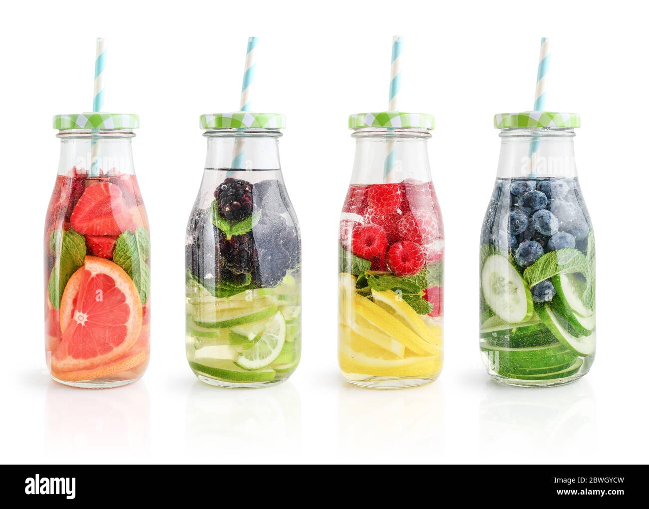 Infused water with fresh fruits, vegetables and berry in bottles ...