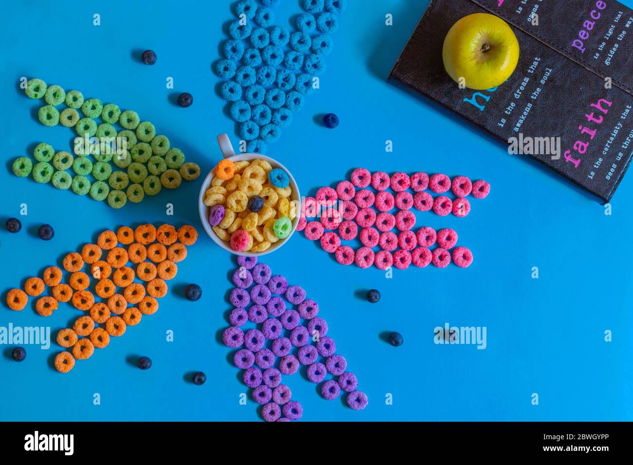 froot loops on blue table in pattern, blue, pink, yellow and purple ...