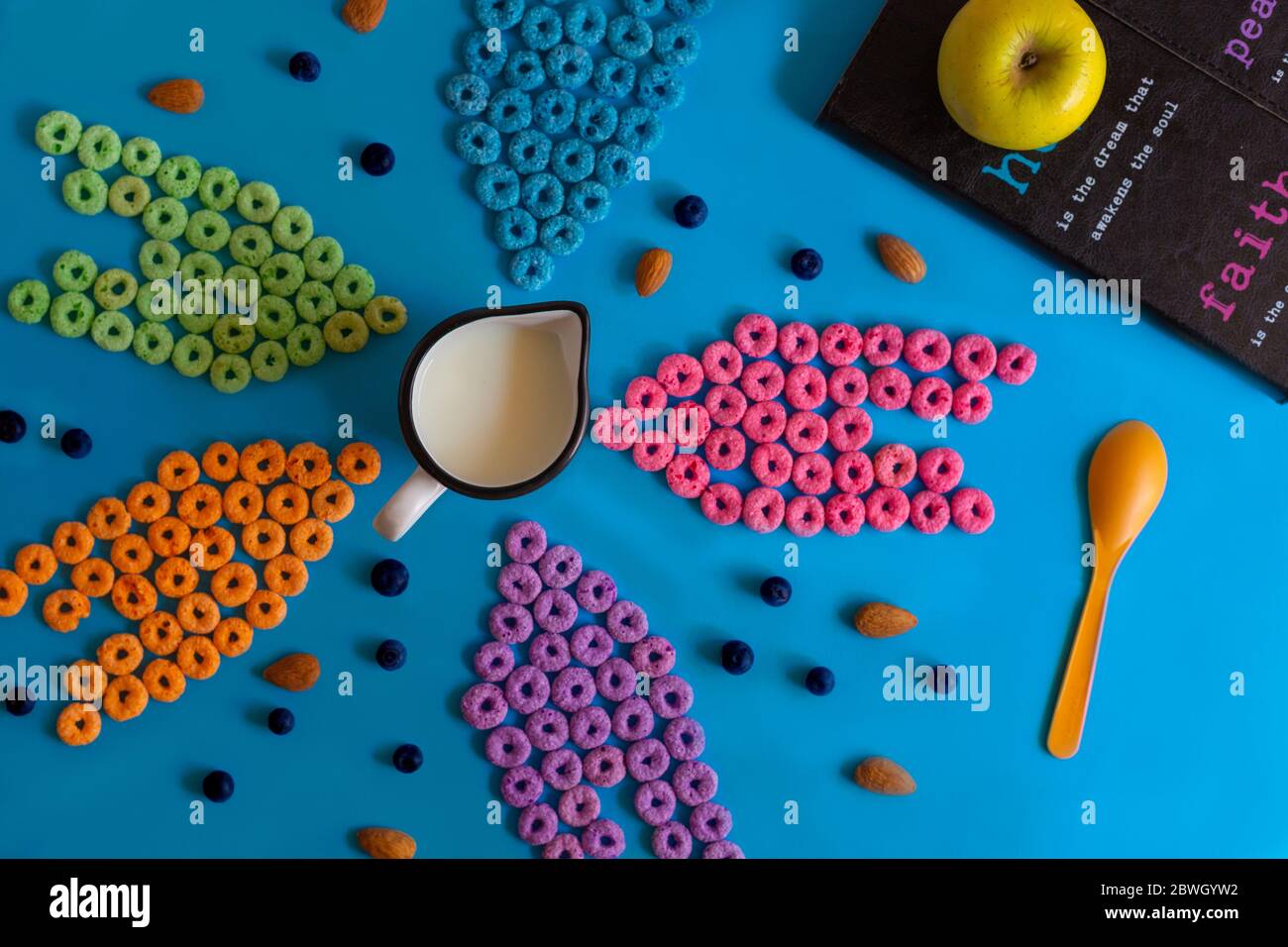 froot loops on blue table in pattern, blue, pink, yellow and purple ...