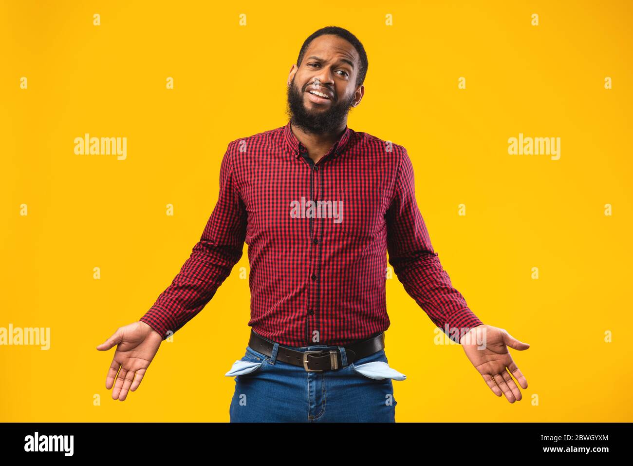 Portrait of black guy showing his empty pockets Stock Photo - Alamy