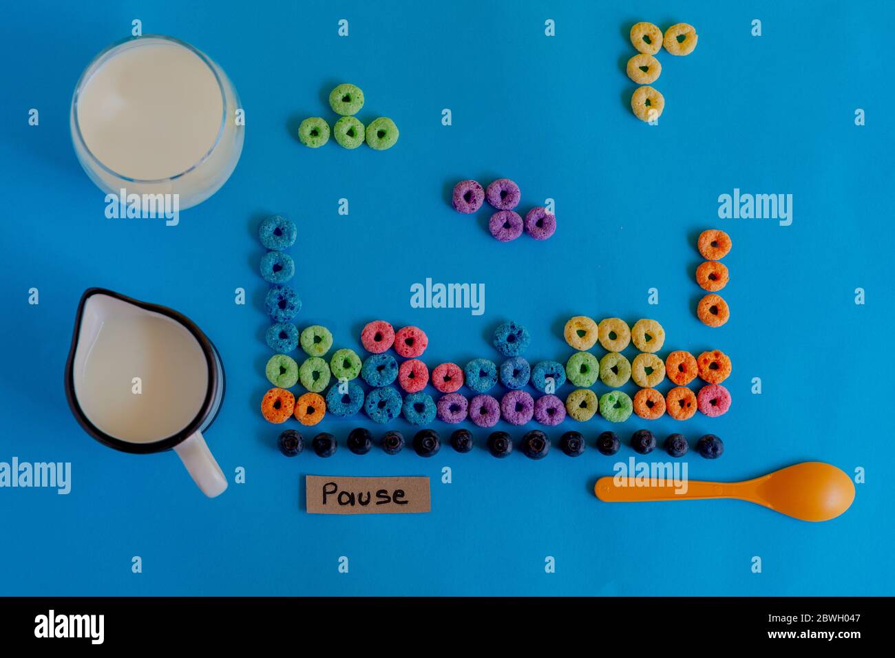 froot loops on blue table in pattern, blue, pink, yellow and purple ...