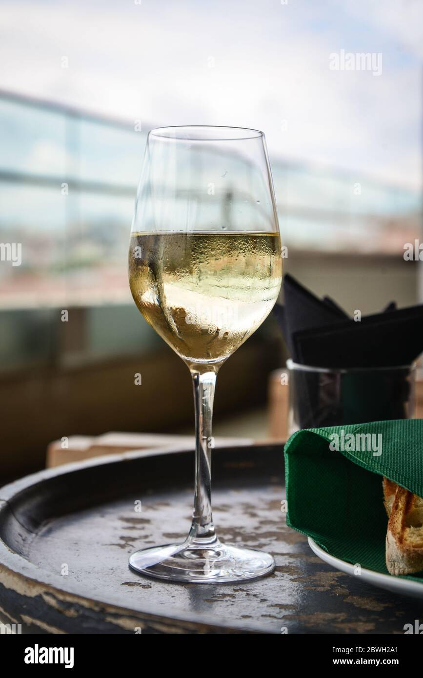 Glass with cold white wine on wooden table at restaurant interior ...