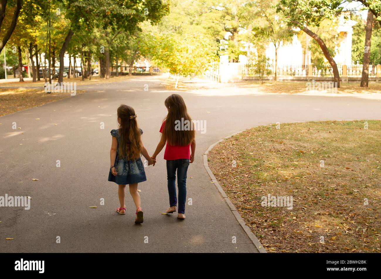 Sisters, Outdoor photo from two little girls. Two little girls walk in ...
