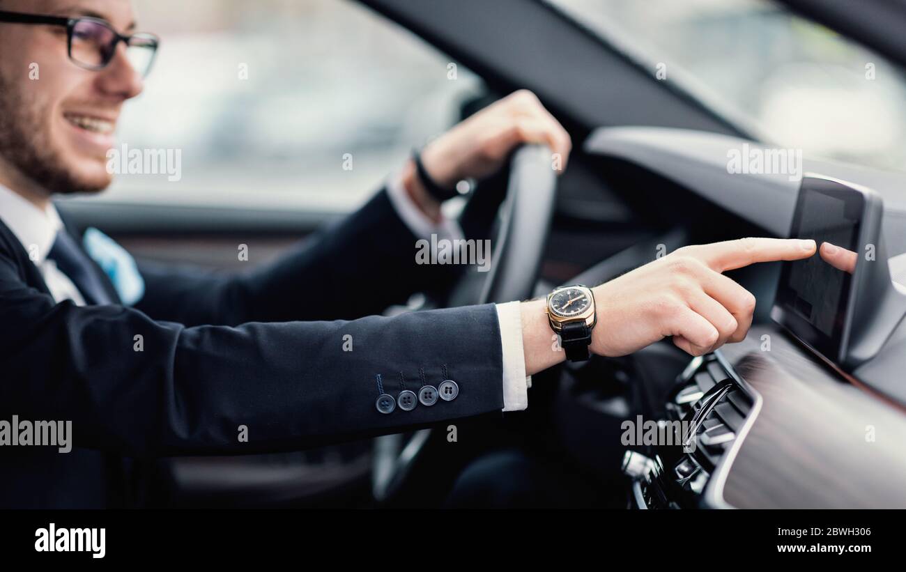 Businessman In Specs Sitting In New Auto Checking Dashboard Stock Photo ...