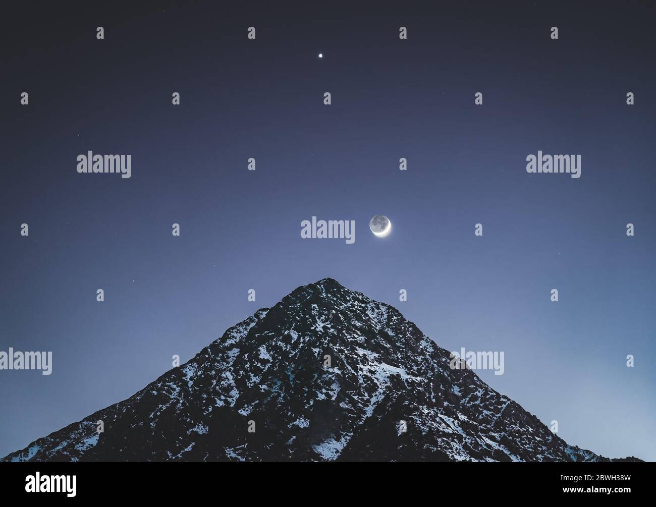 Night fall scene with moon and stars above Imlil village. Small village ...