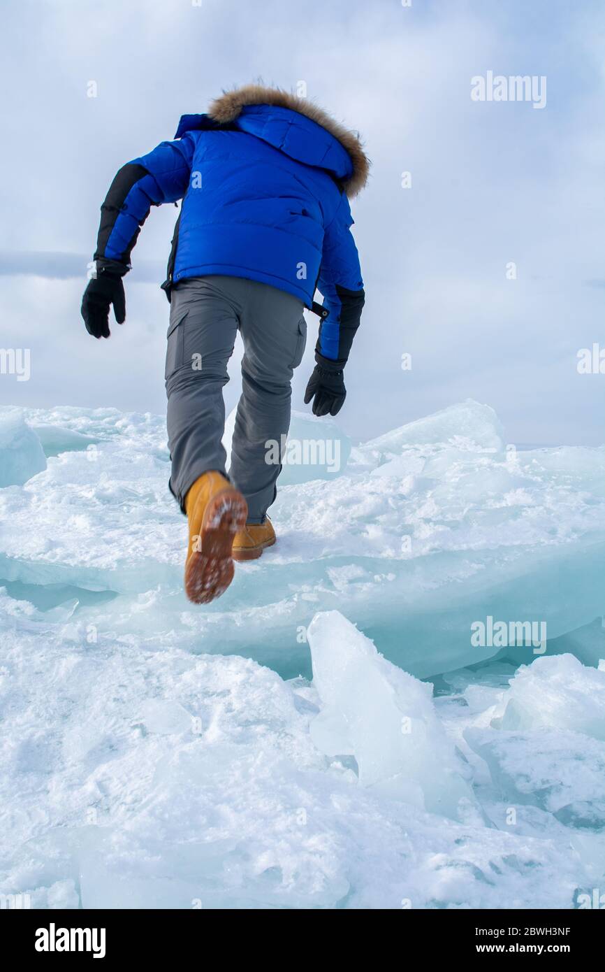 Man walking on ice in frozen lake at Lake Bikal, Russia Stock Photo - Alamy