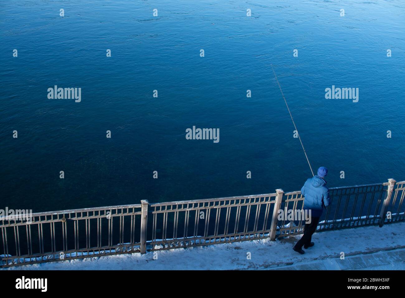 Man fishing in blue river, landscape photography Stock Photo - Alamy