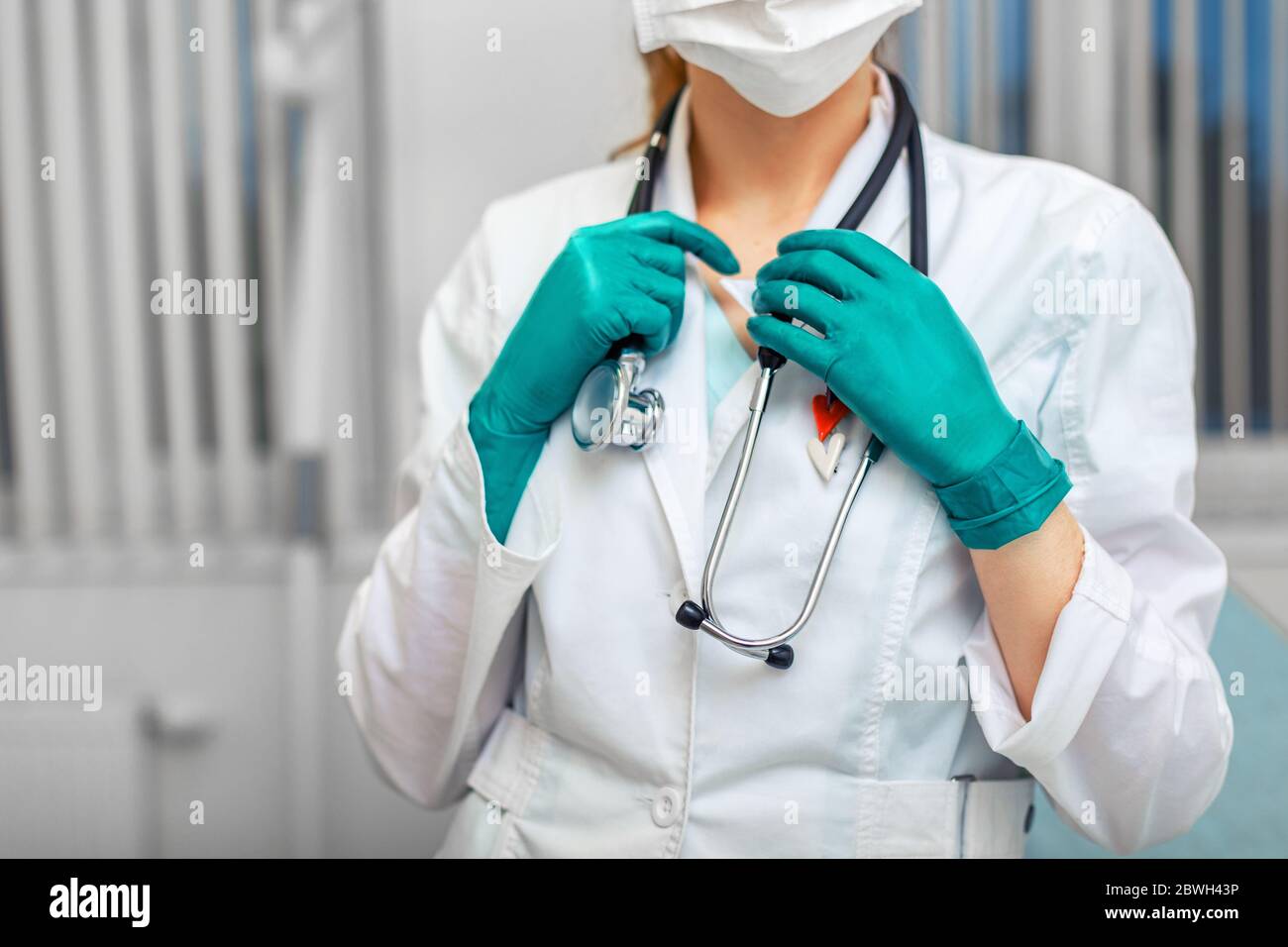 Doctor's hand in white coat holding a phonendoscope on the background ...
