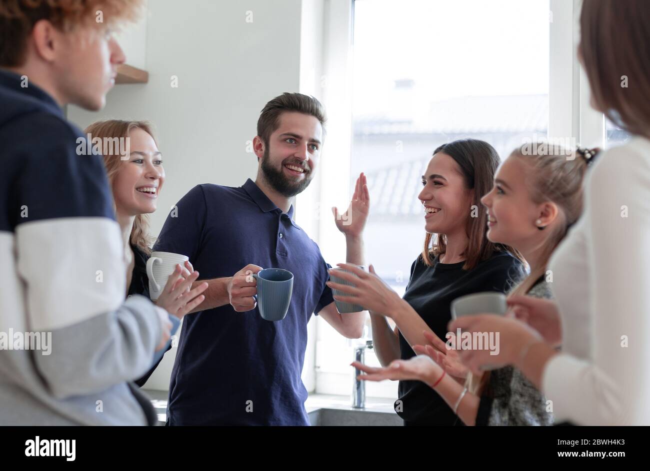 Group of happy men and women in conversation while drinking tea Stock ...