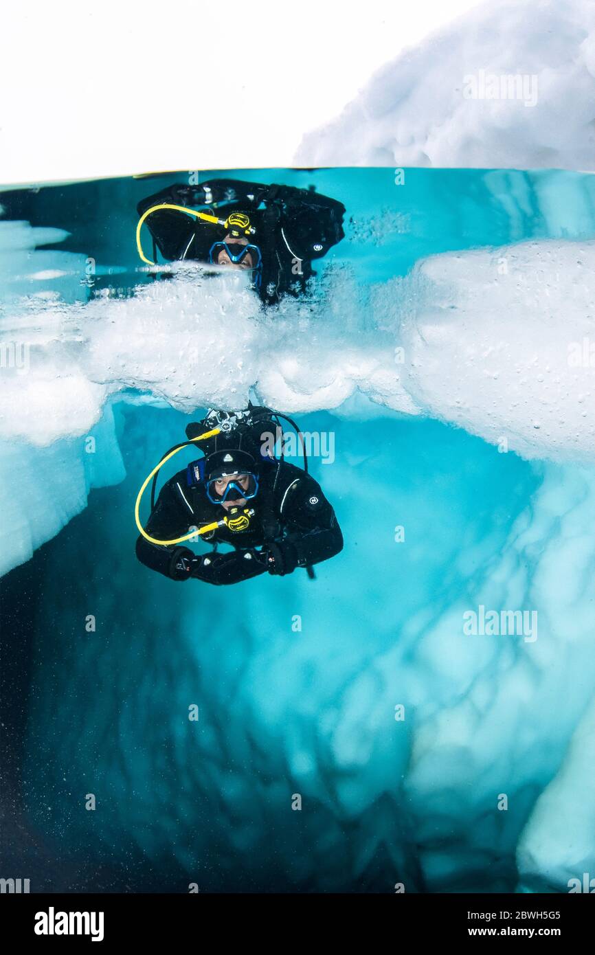 Spit image of a scuba diver diving close to an iceberg, only in ...