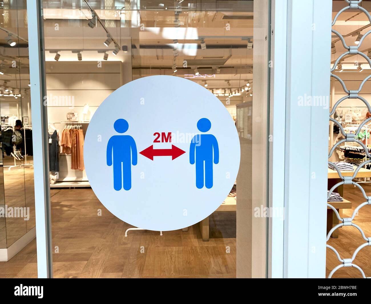 Sticker keep distance on the glass in store in the mall. Concept of ...