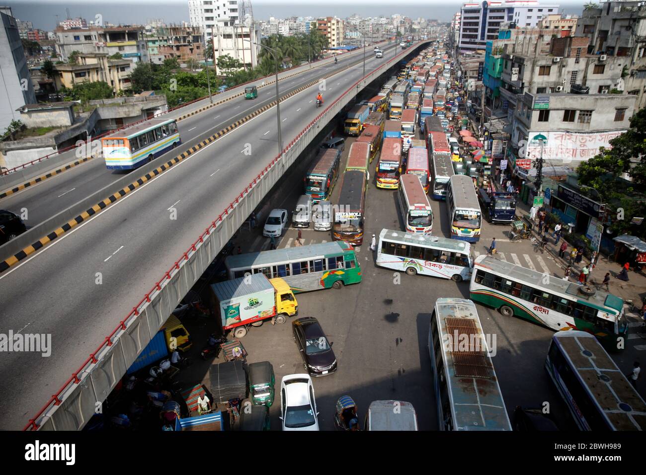 Vehicles wait in long queues in front of a traffic signal near Hanif ...