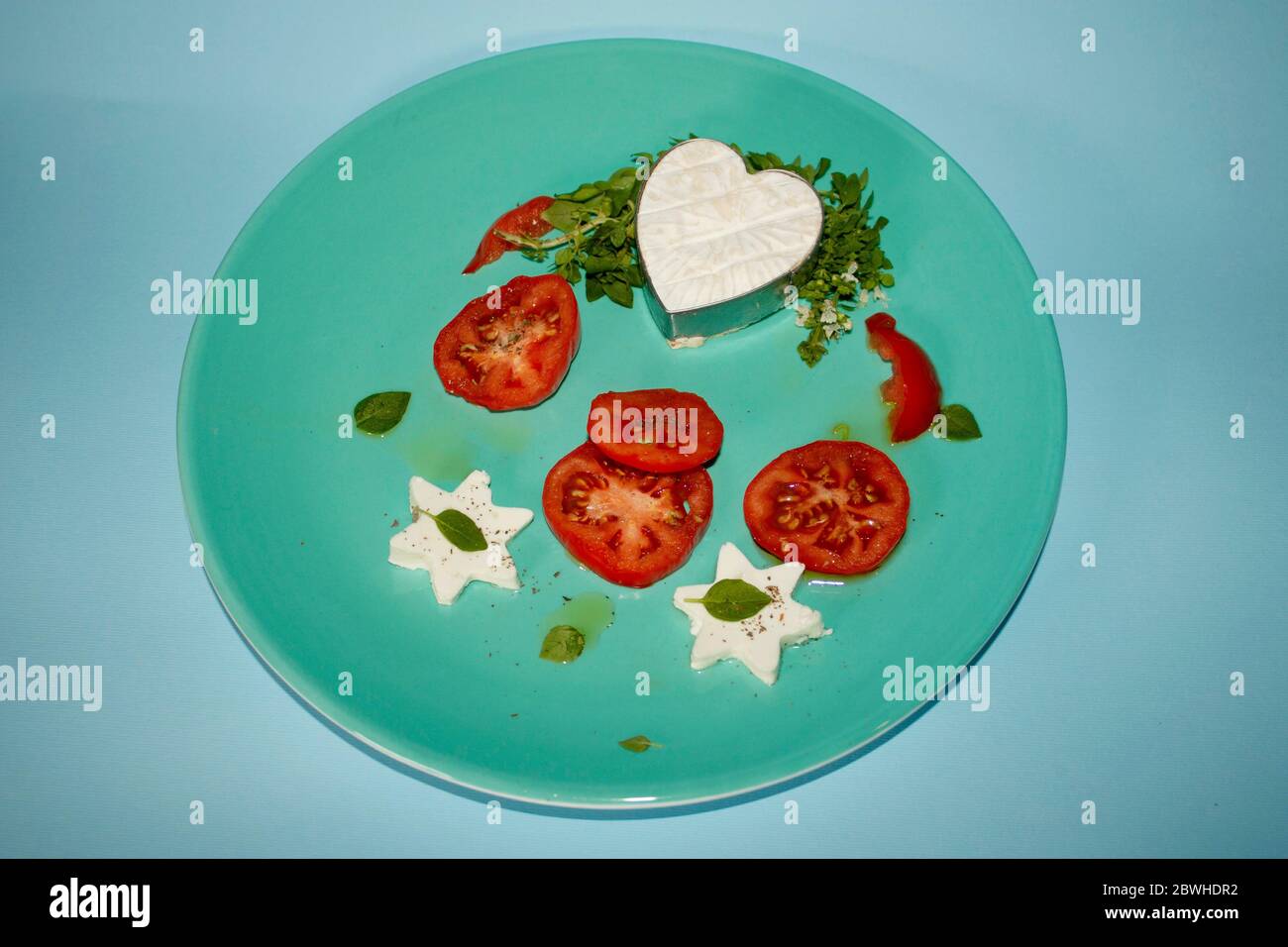 Panela cheese star salad with heart-shaped brie cheese with tomato ...