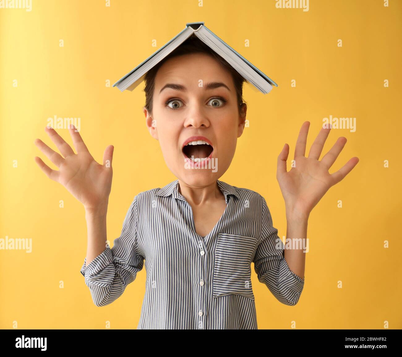 Stressed female student with big head on color background Stock Photo ...