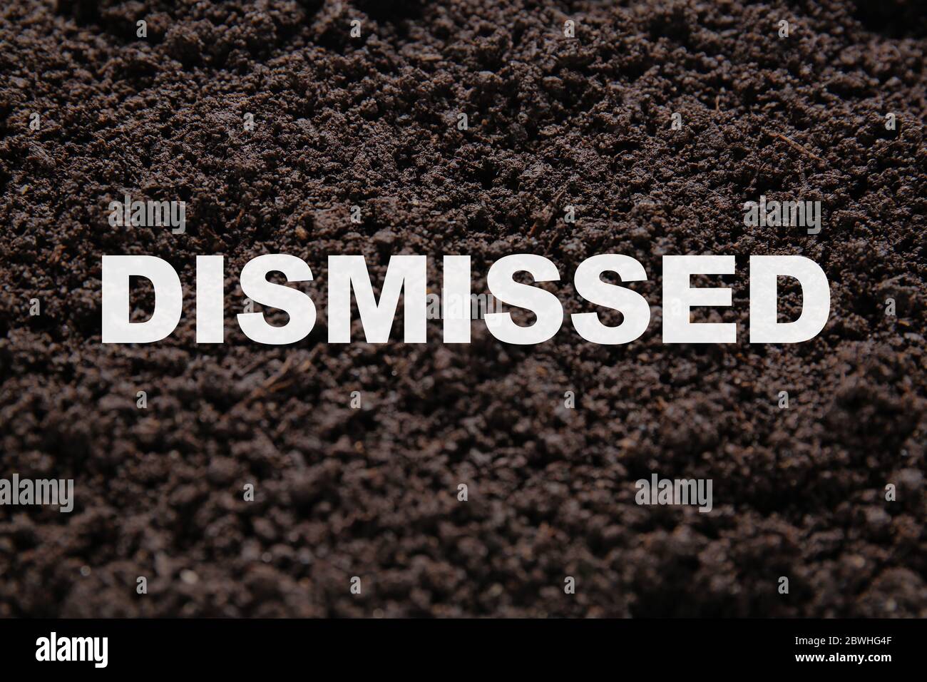 Word DISMISSED above texture of soil Stock Photo - Alamy