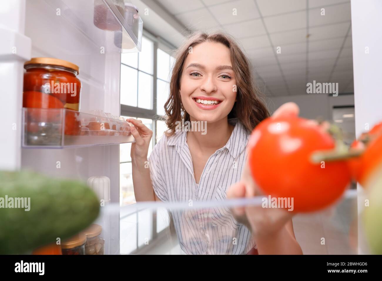 Woman putting food in fridge hi-res stock photography and images - Alamy