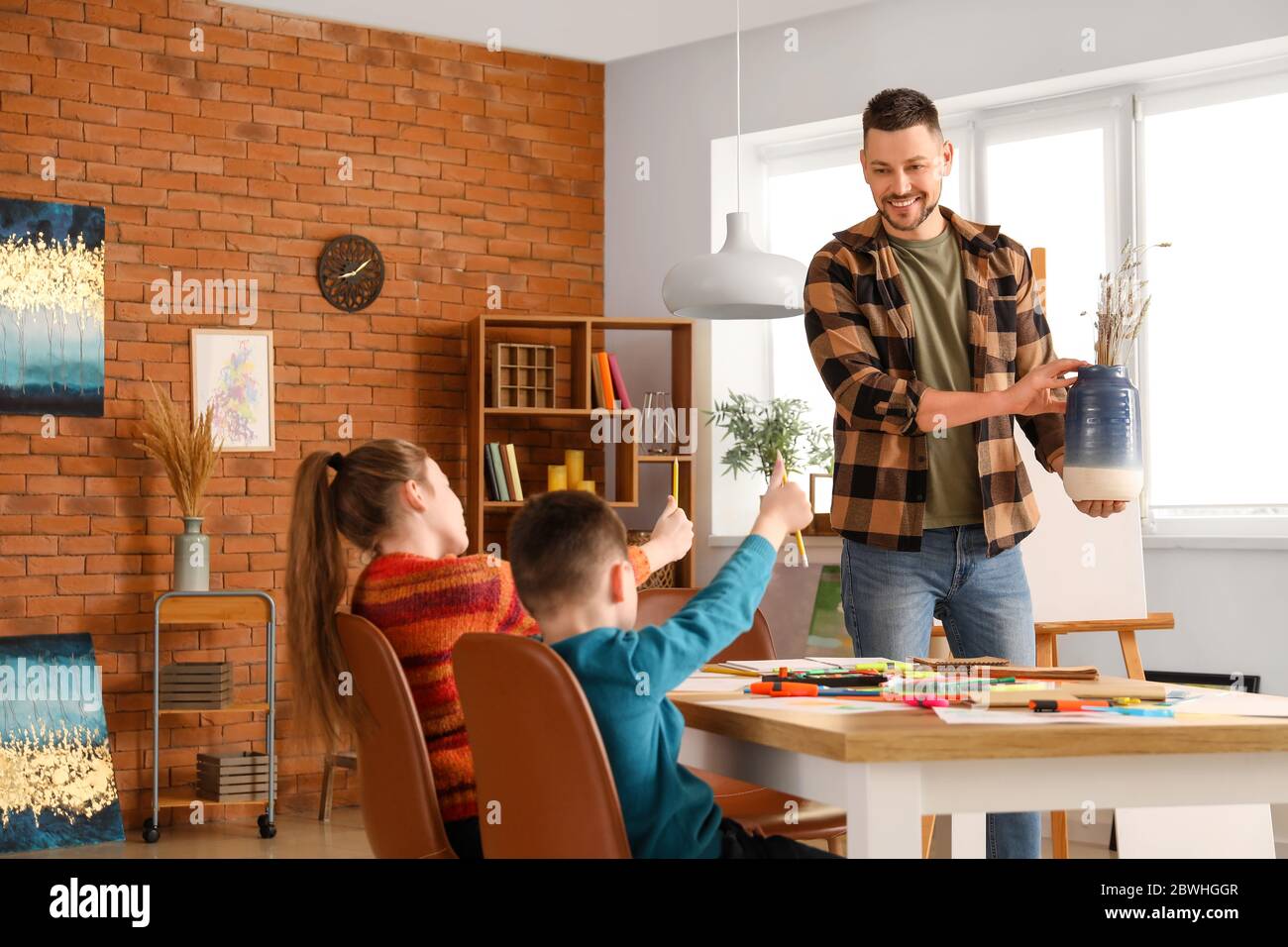 Drawing teacher giving optional classes at school Stock Photo - Alamy