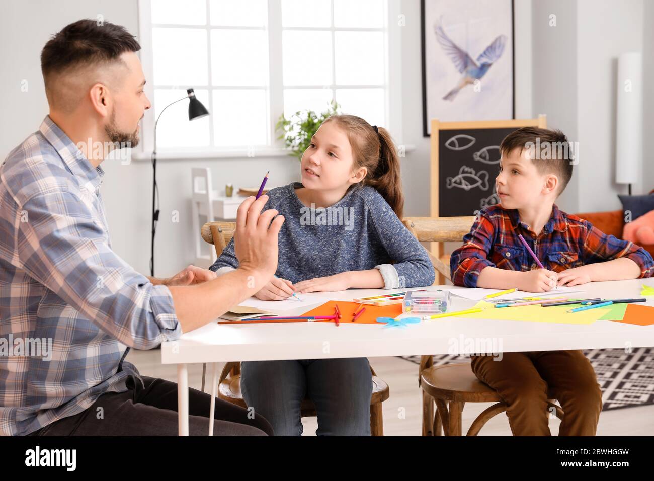 Drawing teacher giving private lessons at home Stock Photo - Alamy