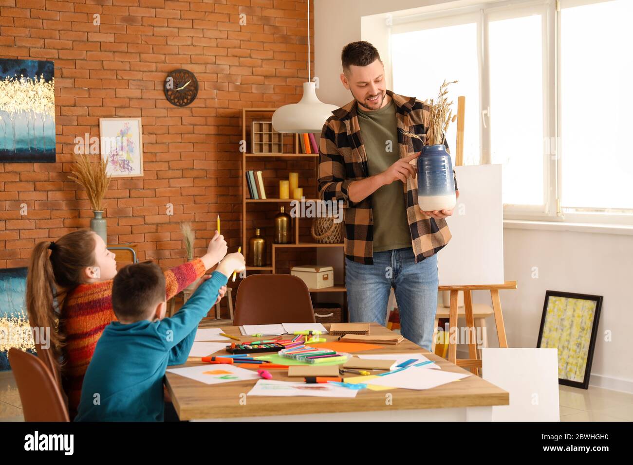 Drawing teacher giving optional classes at school Stock Photo - Alamy