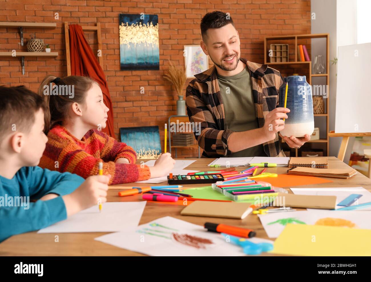 Drawing teacher giving optional classes at school Stock Photo - Alamy