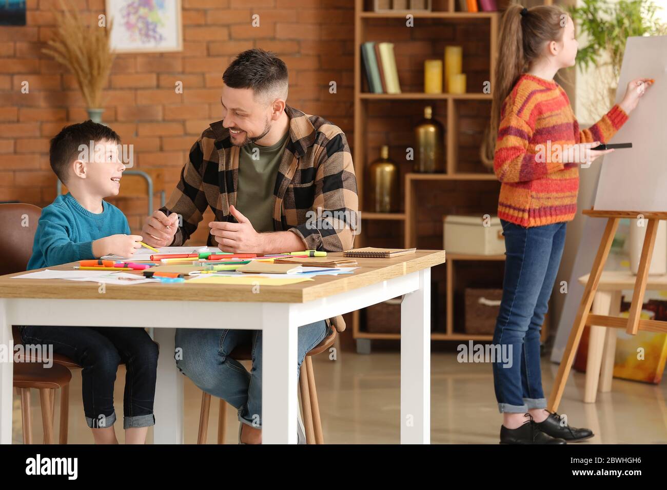 Drawing teacher giving optional classes at school Stock Photo - Alamy