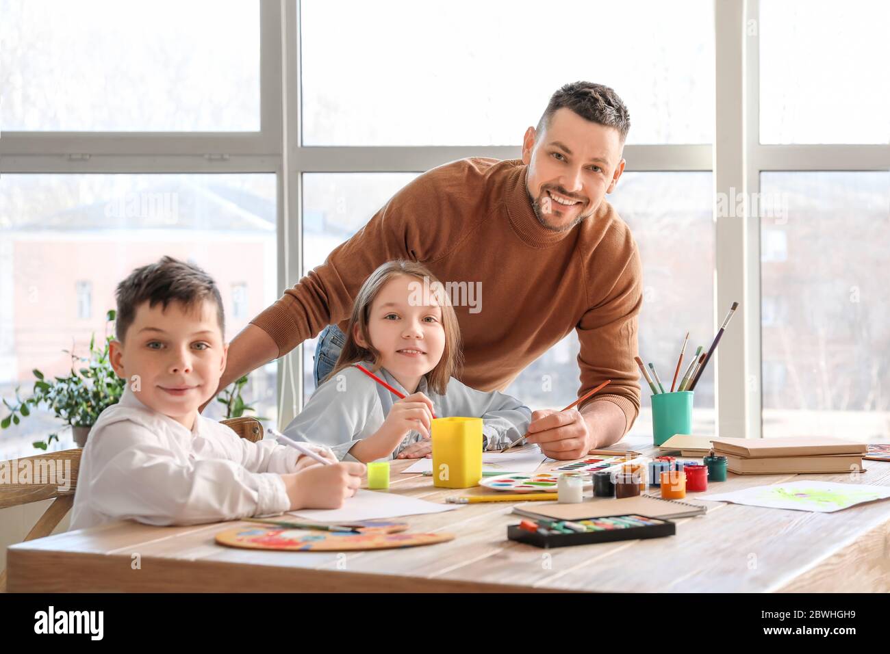 Drawing teacher giving optional classes at school Stock Photo - Alamy