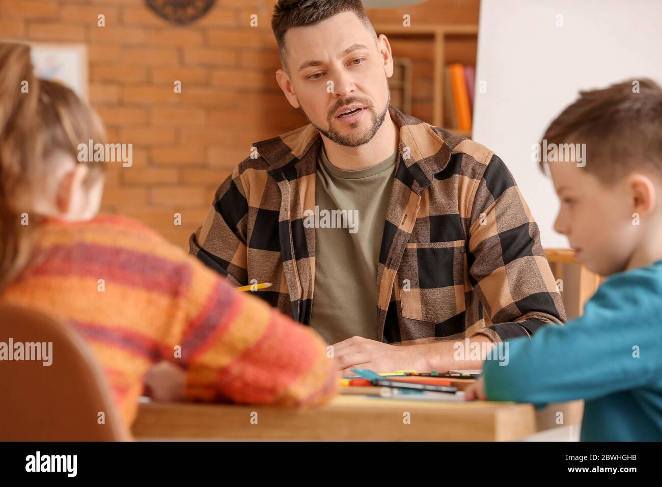 Drawing teacher giving optional classes at school Stock Photo - Alamy