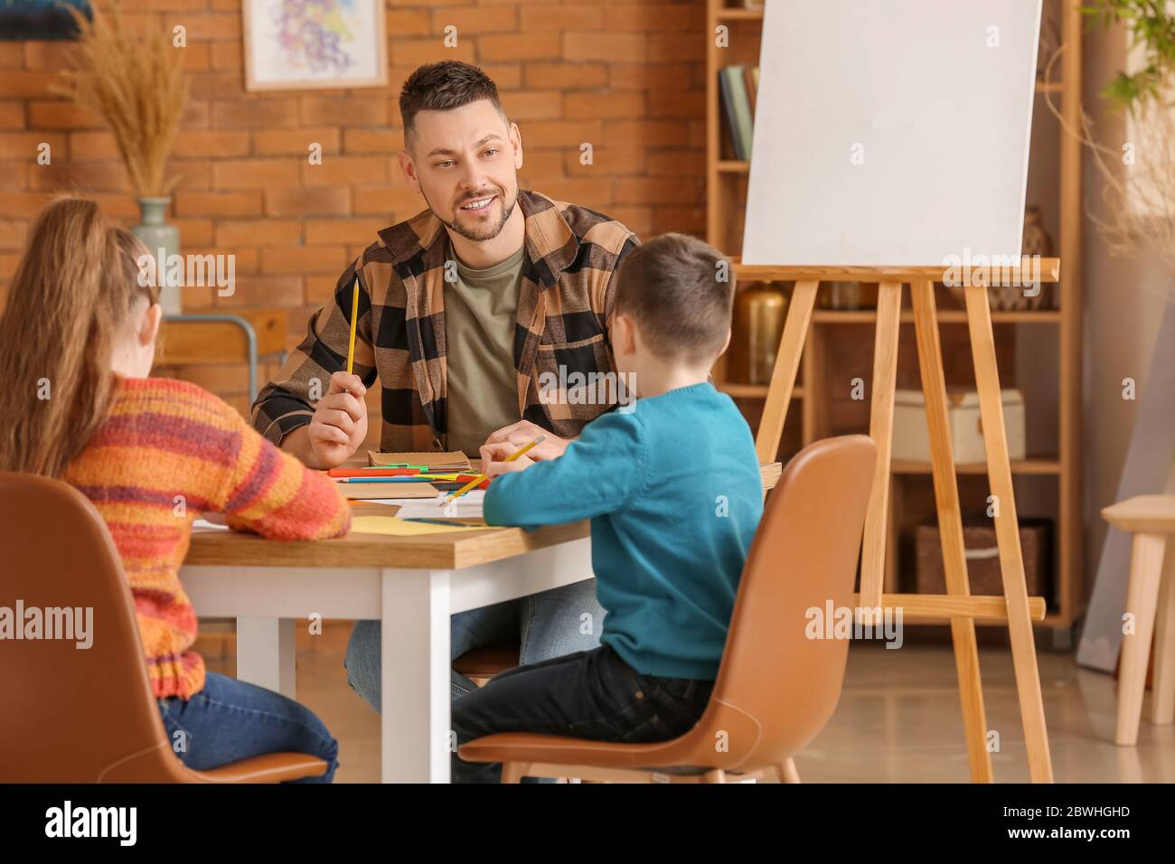 Drawing teacher giving optional classes at school Stock Photo - Alamy