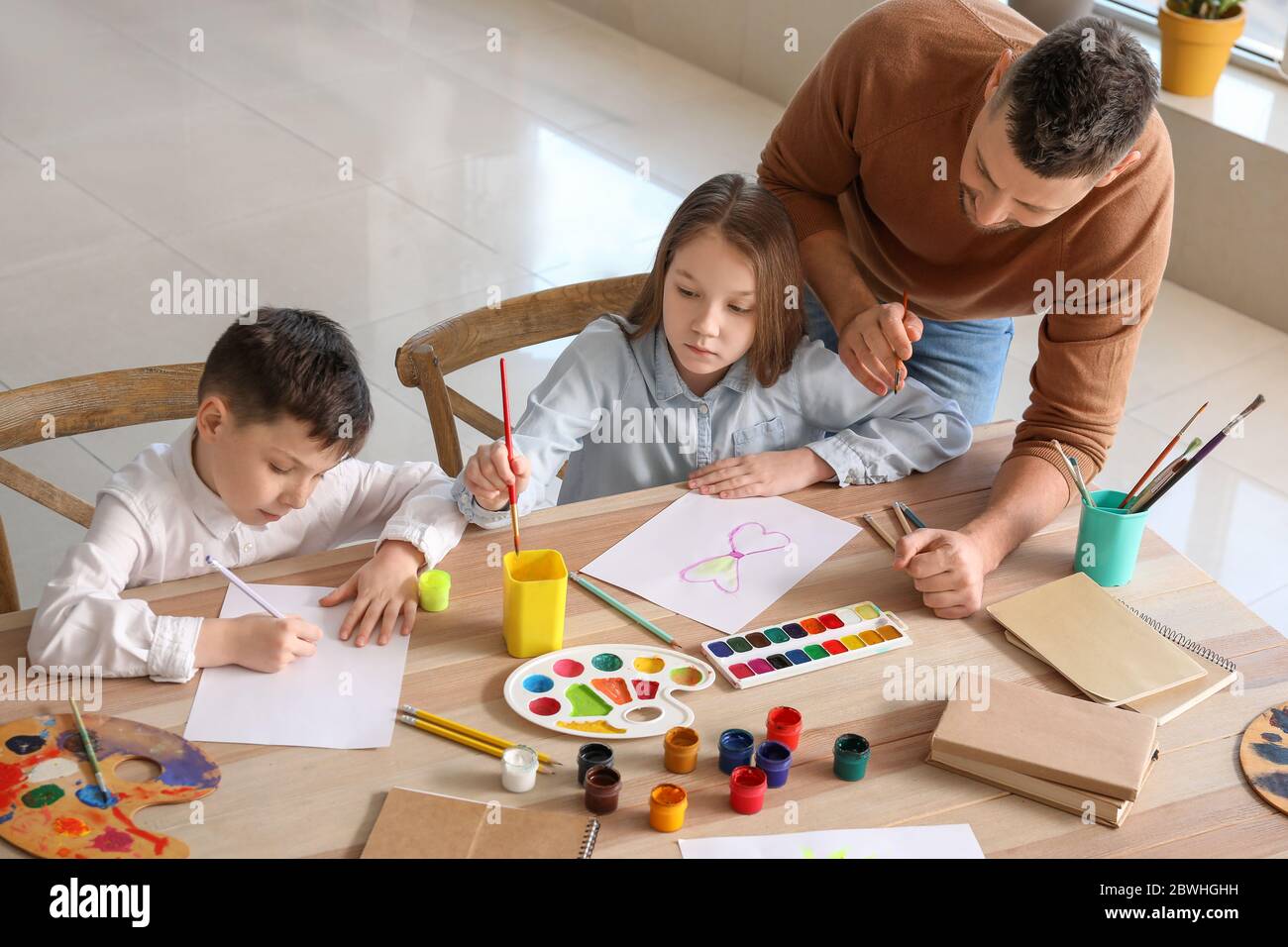 Drawing teacher giving optional classes at school Stock Photo - Alamy