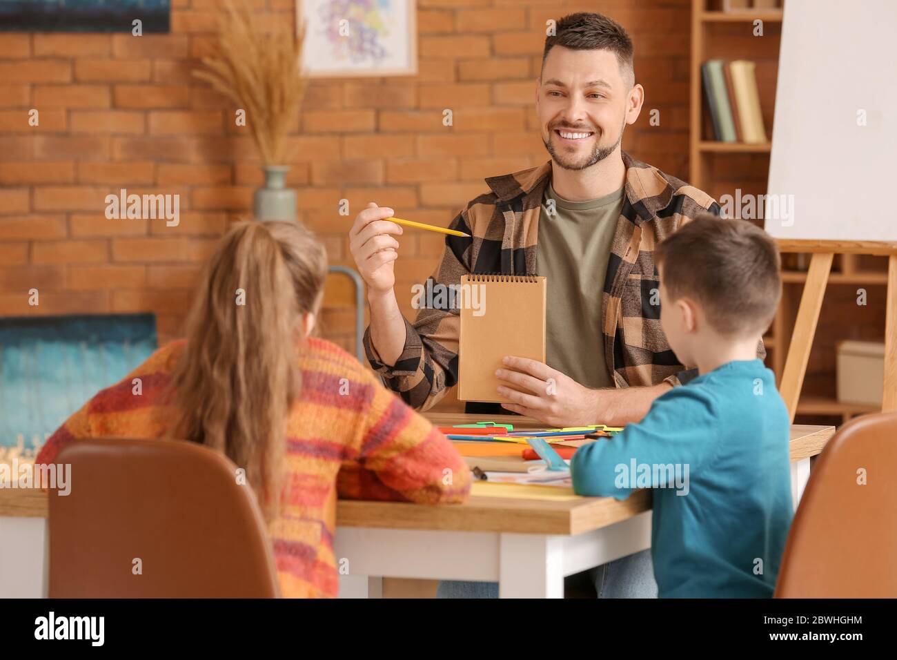 Drawing teacher giving optional classes at school Stock Photo - Alamy